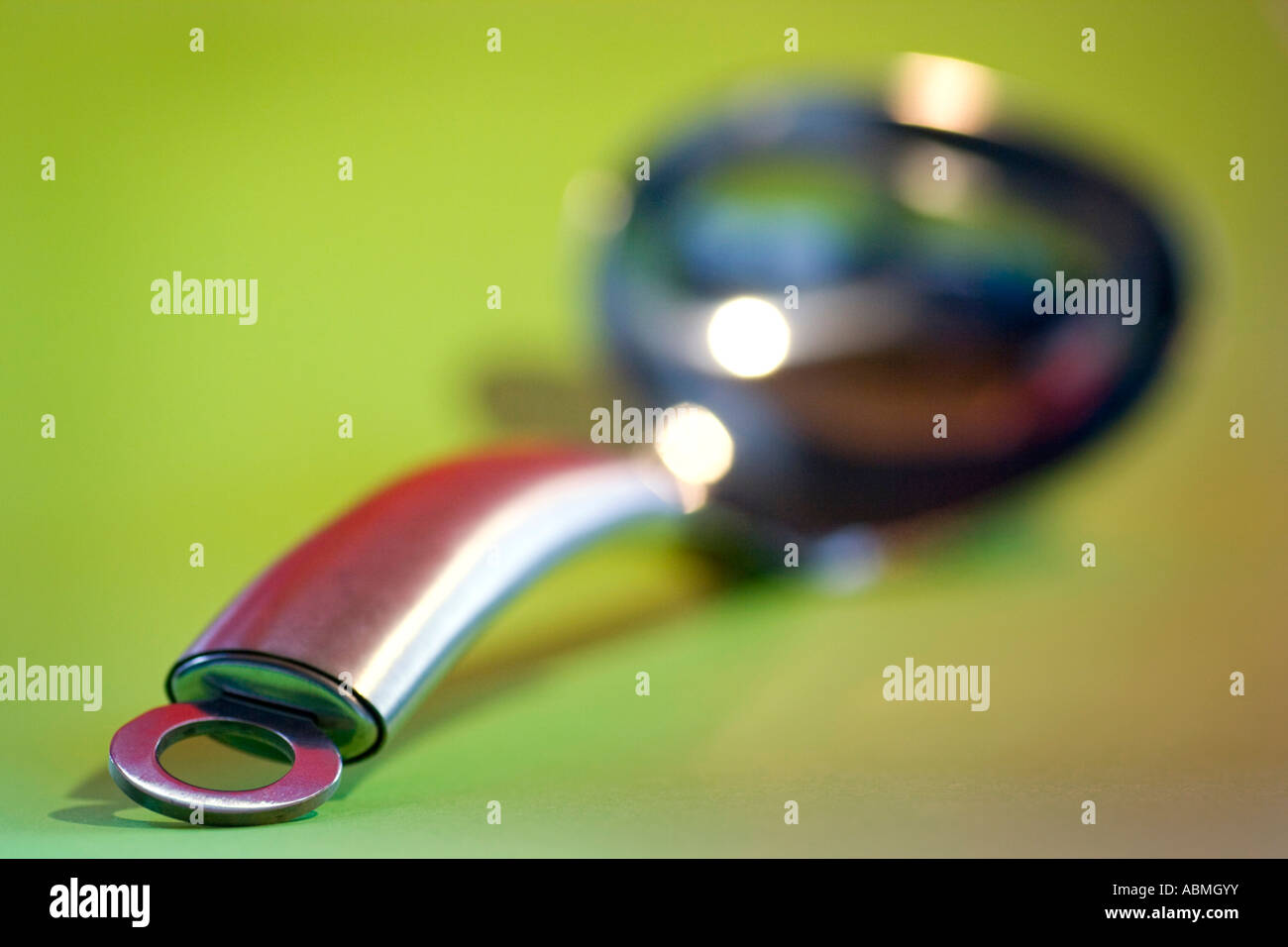 horizontal landscape photo of a shiny stainless steel ladle in a studio ...