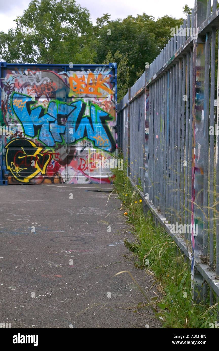 Graffiti on metal railings and a storage container Stock Photo - Alamy