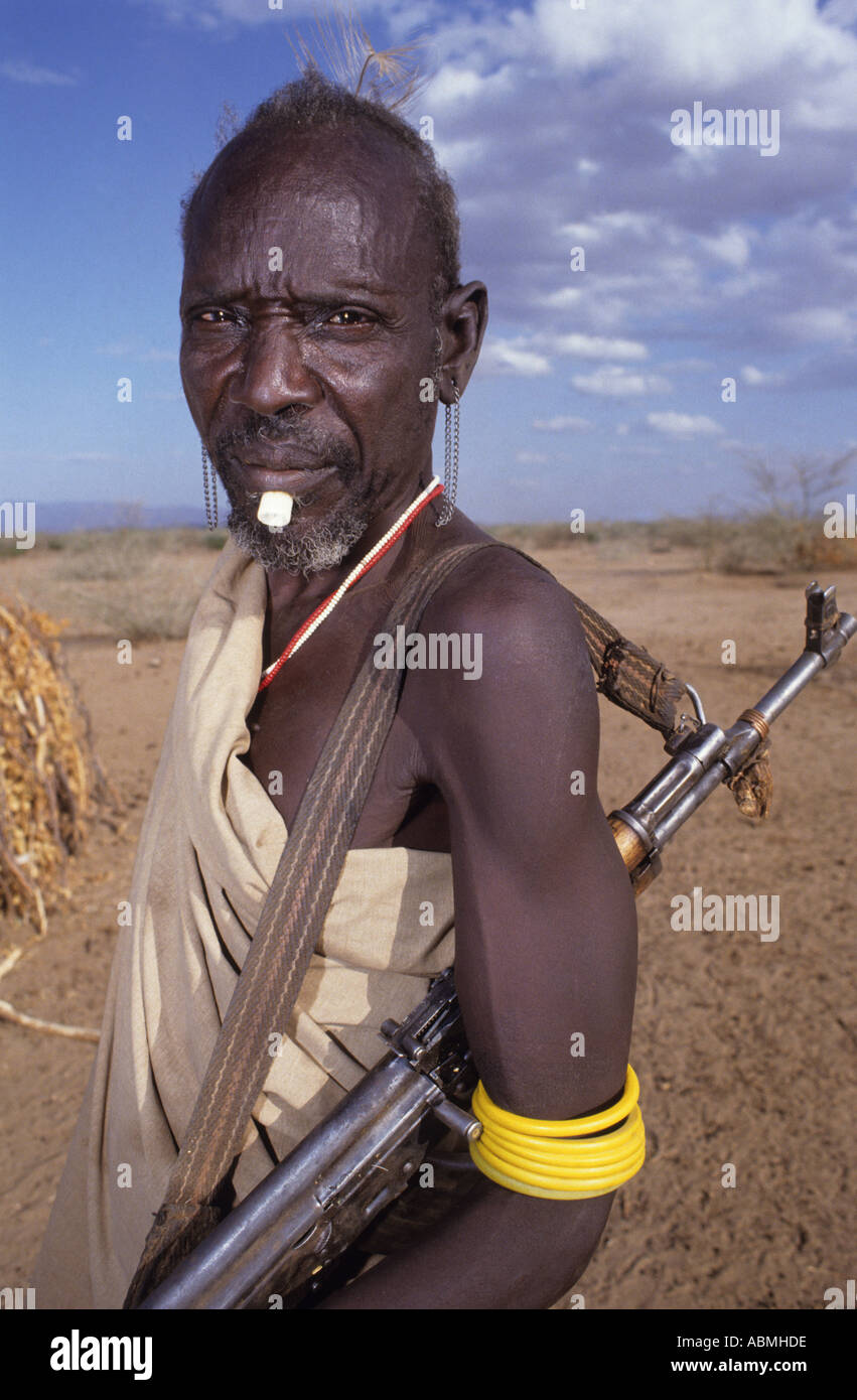 A Turkana man and his AK47 which he uses for protecting his family's ...