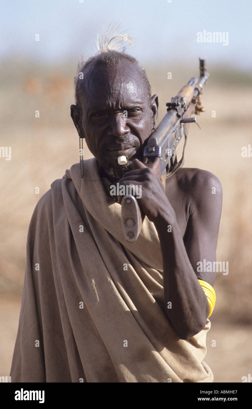A Turkana man and his AK47 which he uses for protecting his family's ...