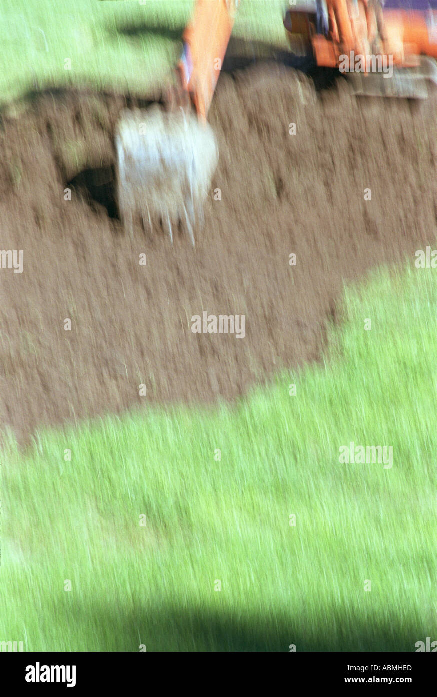 mechanical digger digging hole in field Stock Photo - Alamy