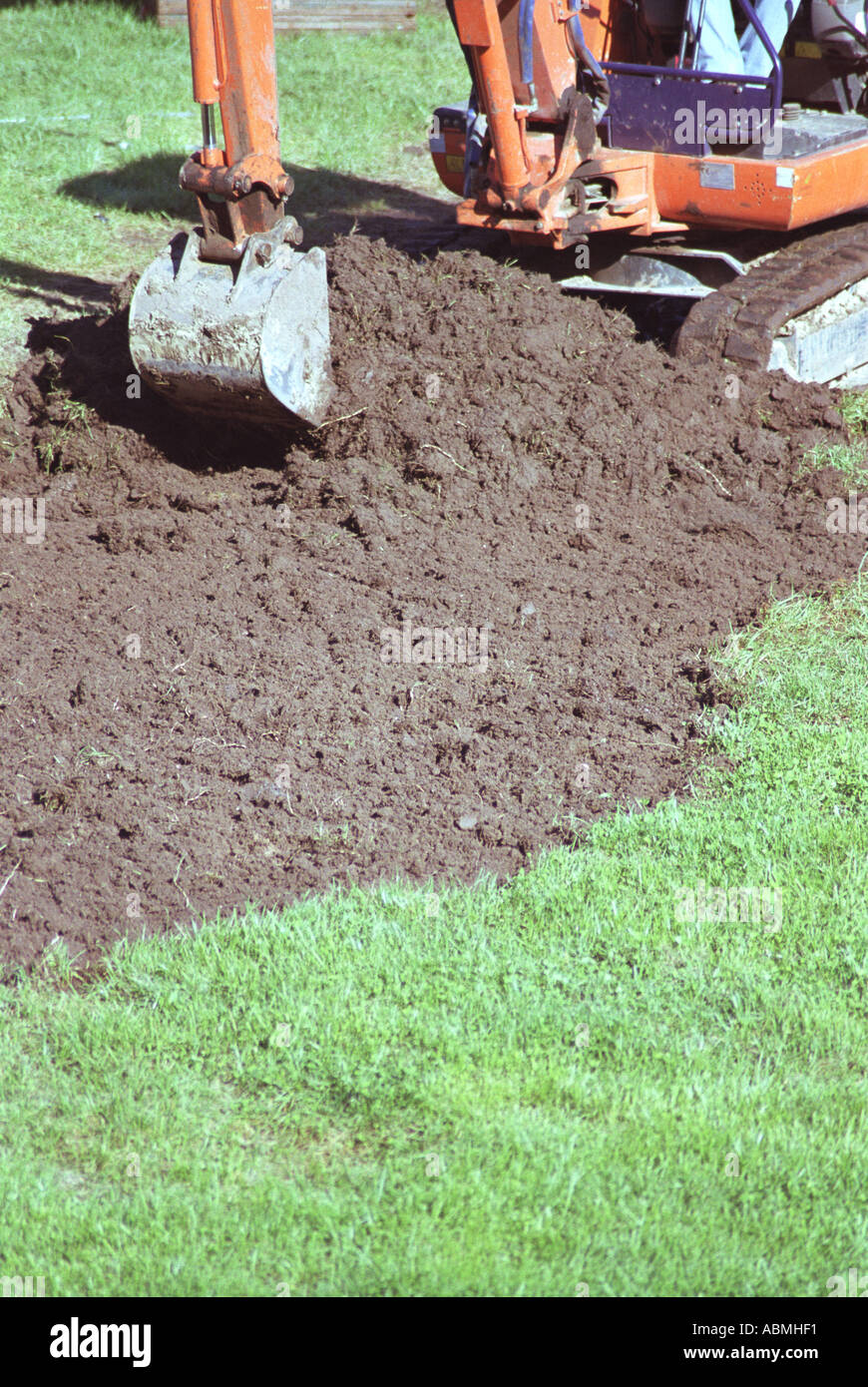 mechanical digger digging hole in field Stock Photo - Alamy