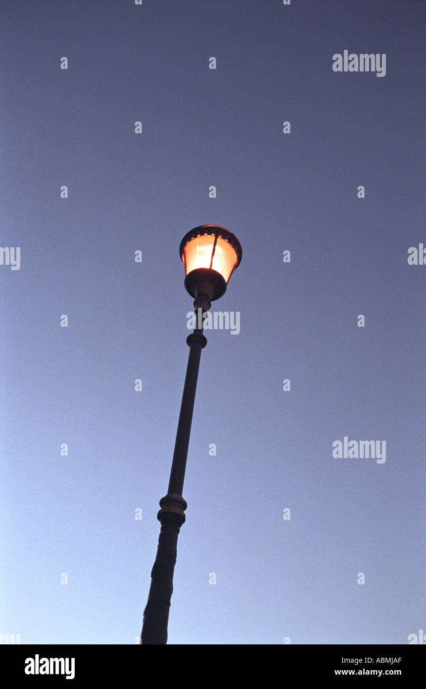 old fashioned lamp post lit Stock Photo - Alamy