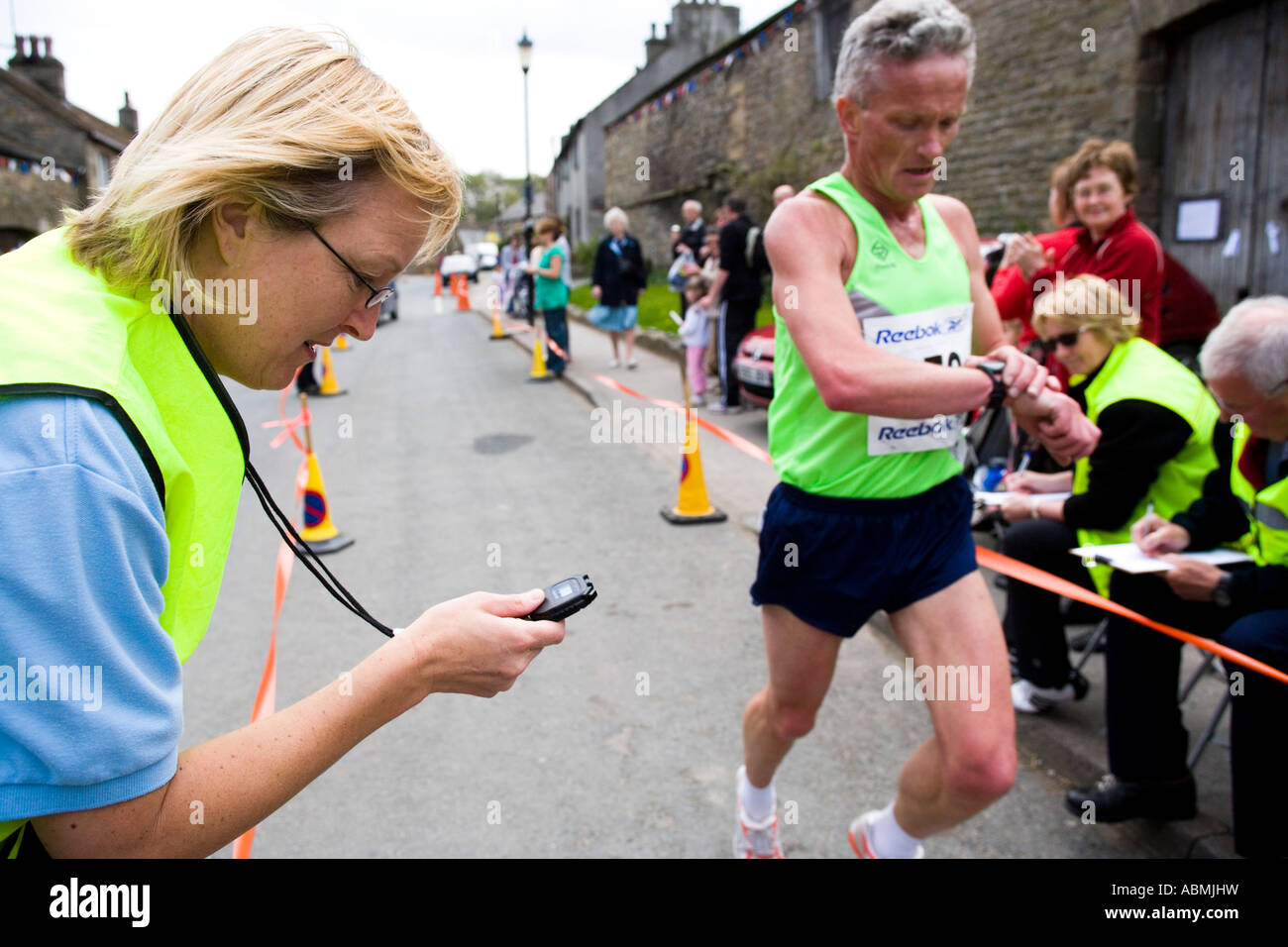 recording the times as runners complete a road race in Lancashire Stock ...