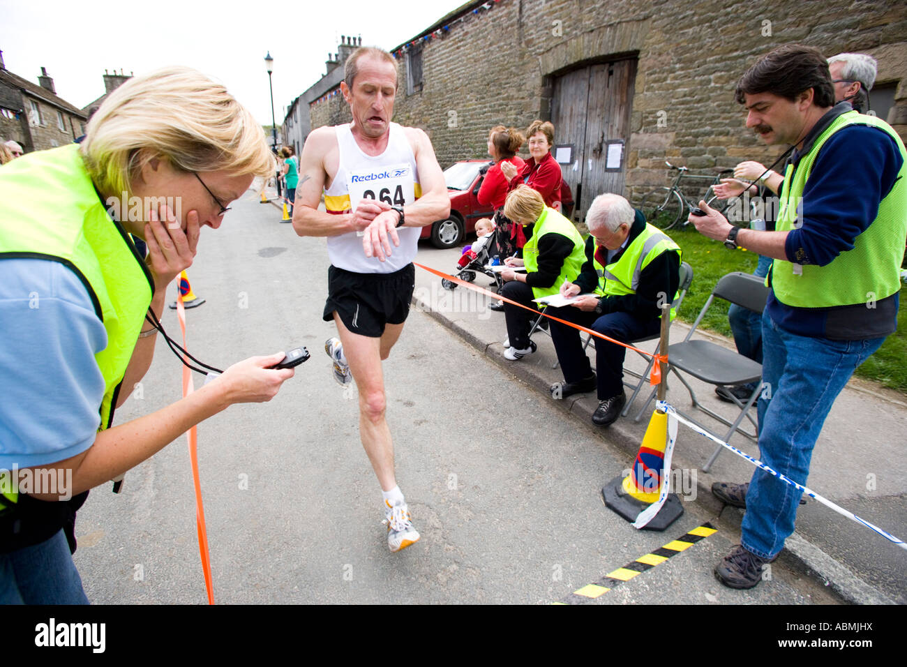 recording the times as runners complete a road race in Lancashire Stock ...