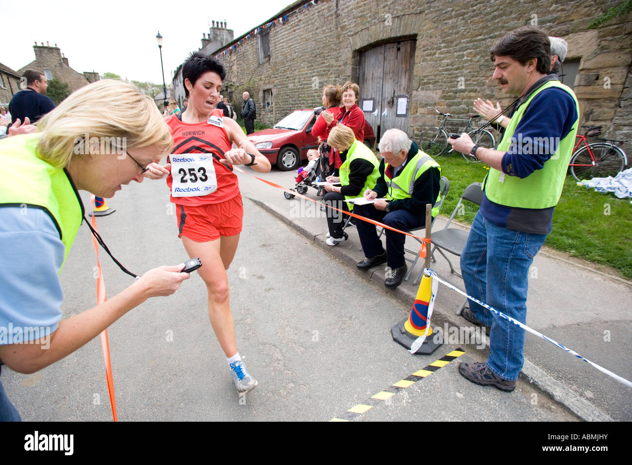 recording the times as runners complete a road race in Lancashire Stock ...
