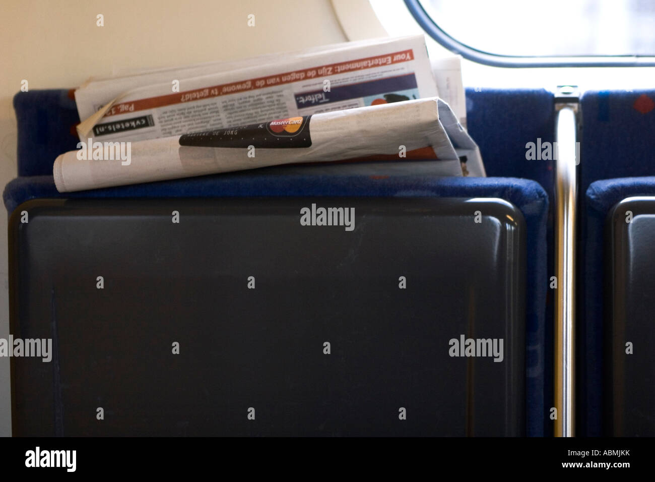 papers stacked between folding chair of a train Stock Photo - Alamy