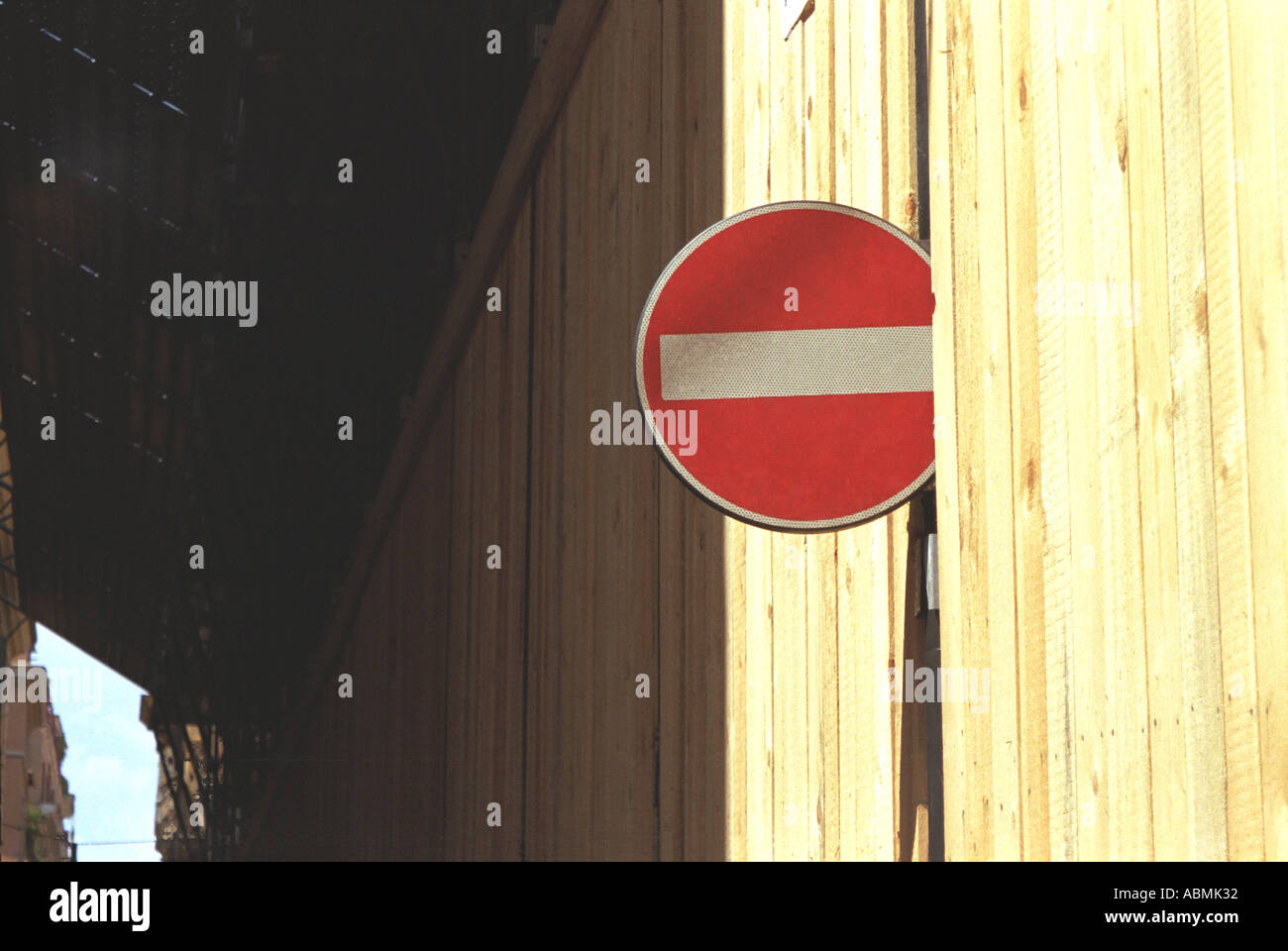 no entry sign sticking out of boarded up building site Stock Photo - Alamy