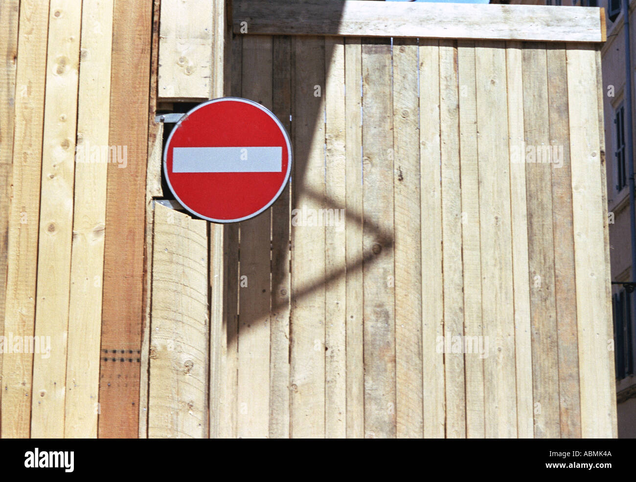 no entry sign sticking out of boarded up building site Stock Photo - Alamy