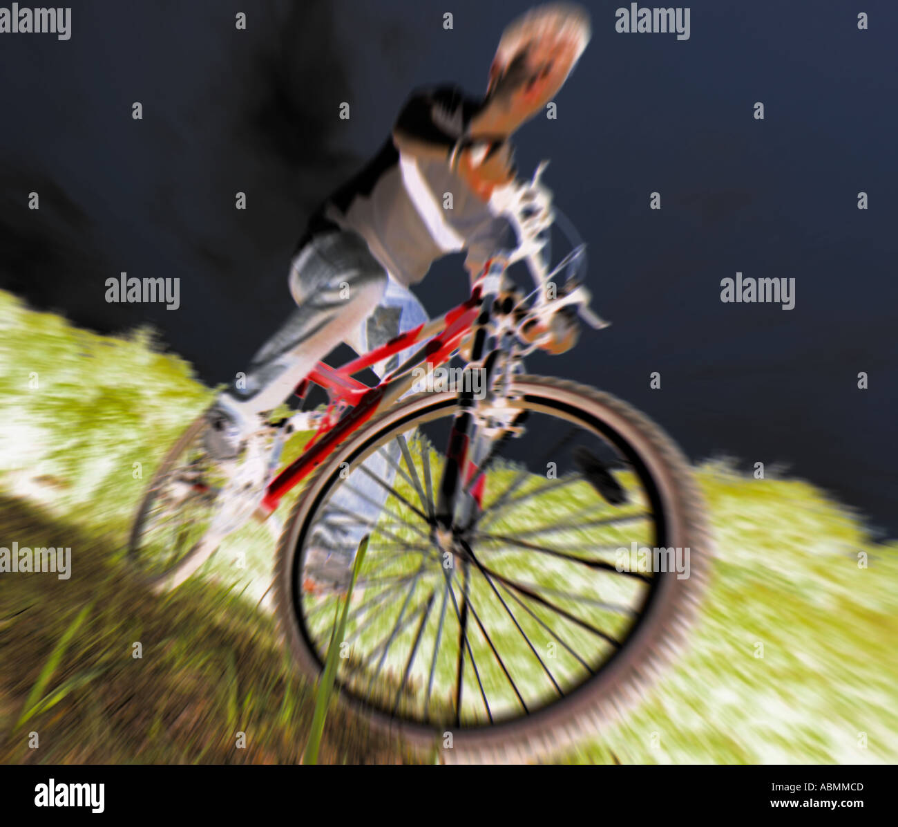 Low wide angle shot of a boy aged 14 riding a bike special anti matter ...