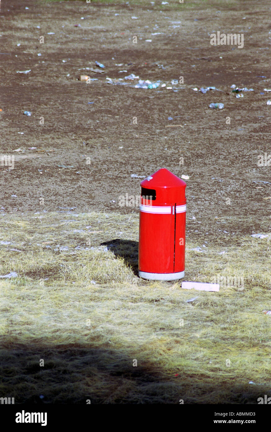 Red rubbish bin abandoned on derelict ground Stock Photo - Alamy