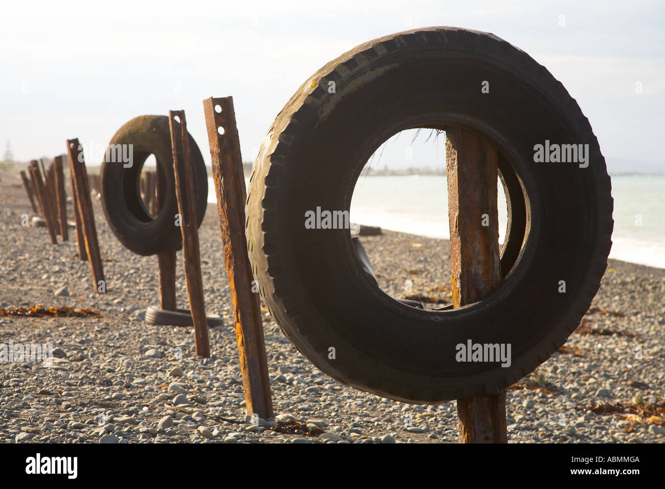 old tyres hanging on sea defenses at the ocean Stock Photo - Alamy