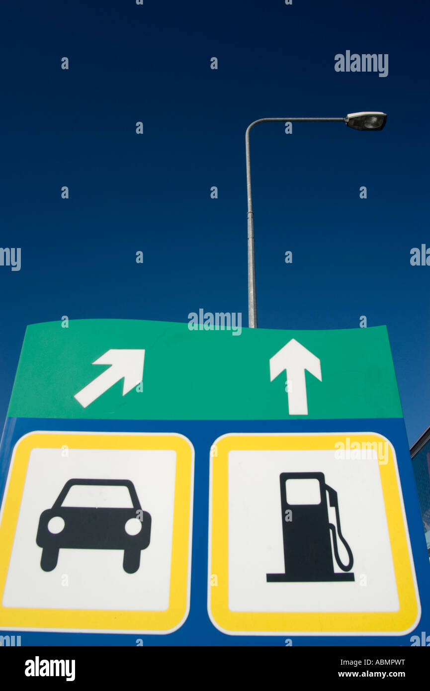 a sign directing traffic at a service station Stock Photo - Alamy