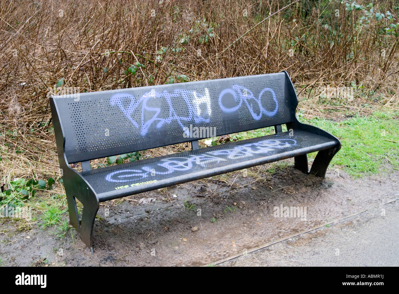 graffiti on a metal bench next to the river rea path Stock Photo - Alamy