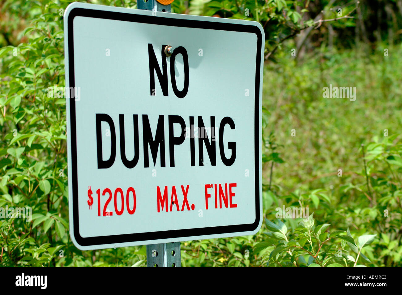 No Dumping sign on public roadway in USA to keep trash out and ...