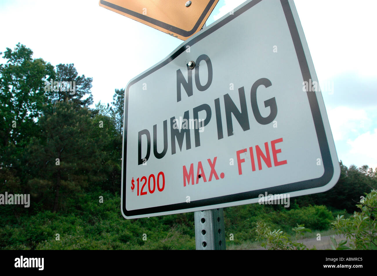 No Dumping sign on public roadway in USA to keep trash out and ...