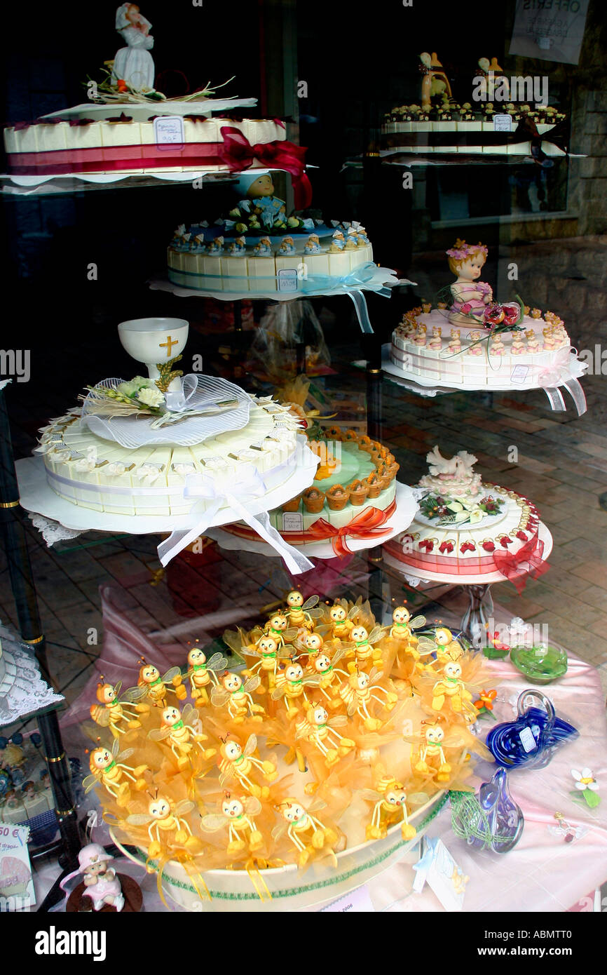 Window of Patisserie shop with Confirmation Cakes and Sweets on display ...