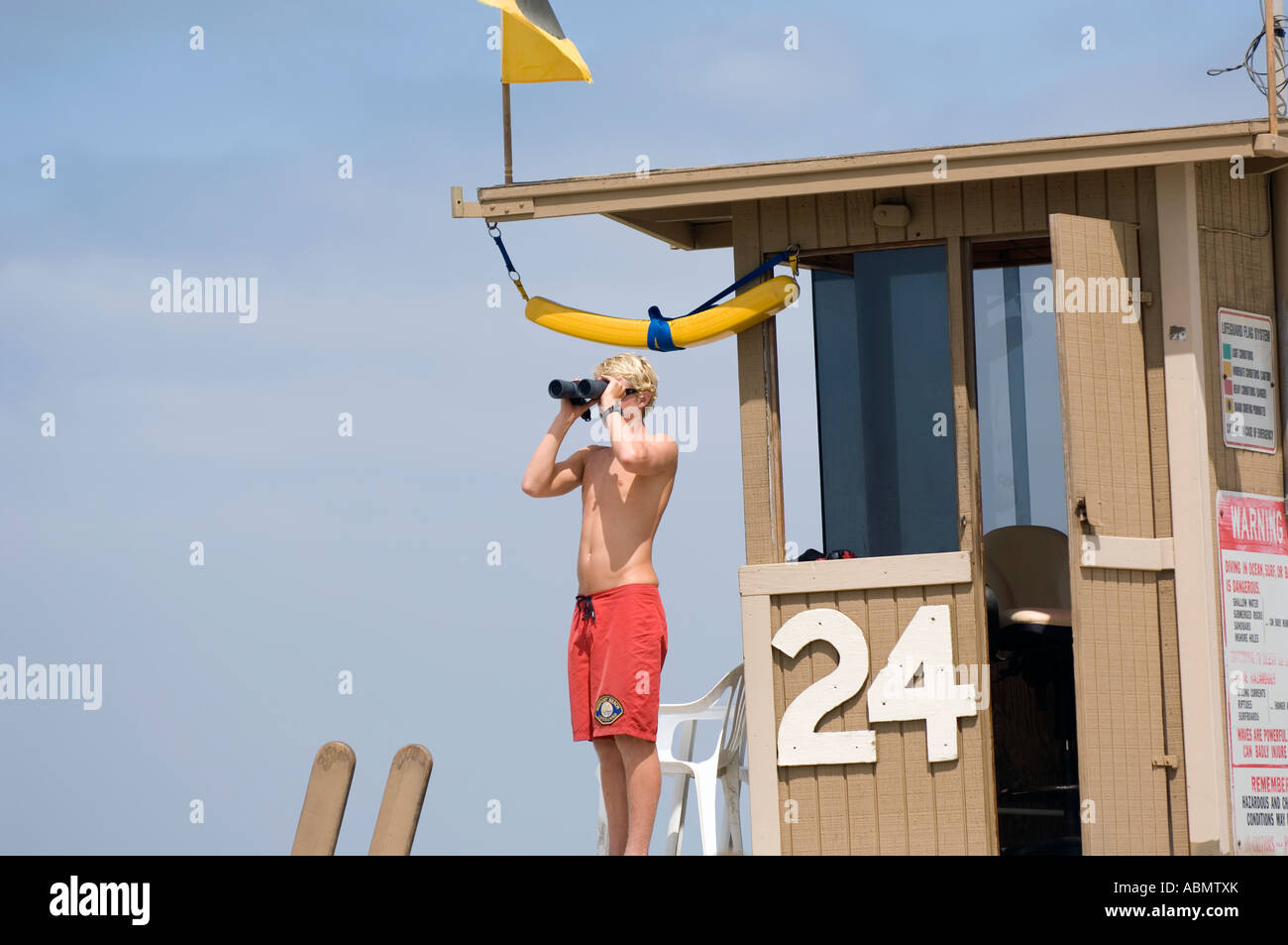 Lifeguard carefully watches beach goers, visitors, and travelers with ...