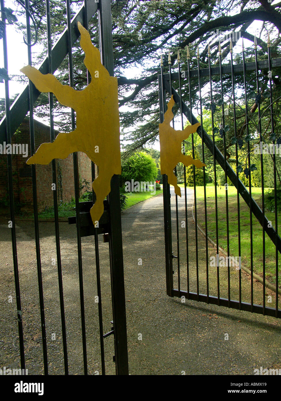 yellow sun on grand black gate the enterance to a private country ...