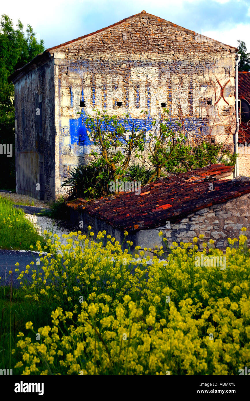 A barn with an old advertising sign in the Charente region of Western ...