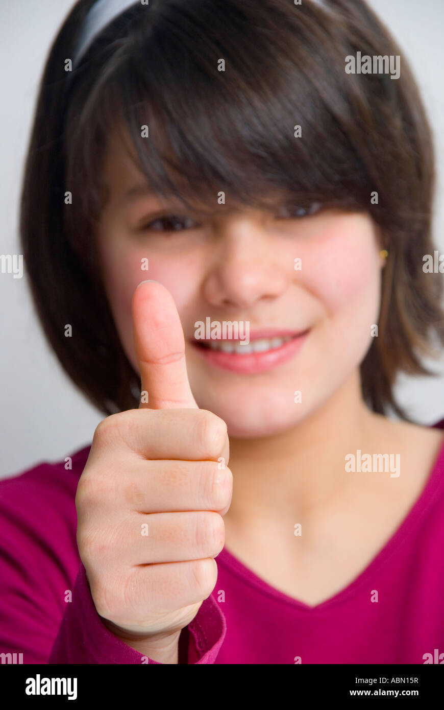 Young 11 year old girl giving the thumbs up sign Stock Photo - Alamy