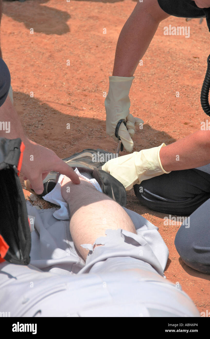 Player with broken lower leg ankle is attended to by fire personal and ...