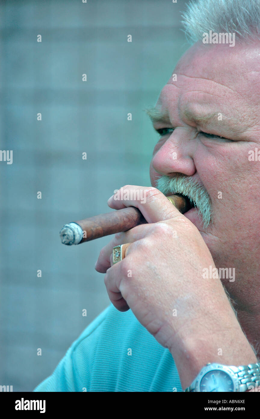 Man Smoking cigar or cigarette which cause health problems from smoke ...