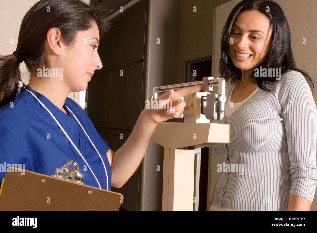 Portrait of nurse taking patients weight Stock Photo - Alamy