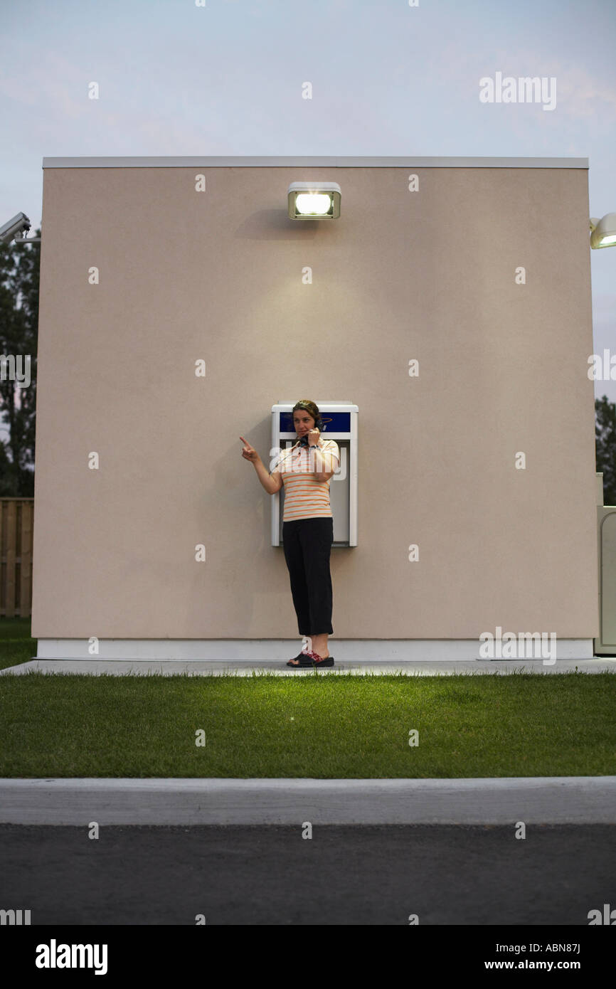 Woman Using Pay Phone Stock Photo - Alamy