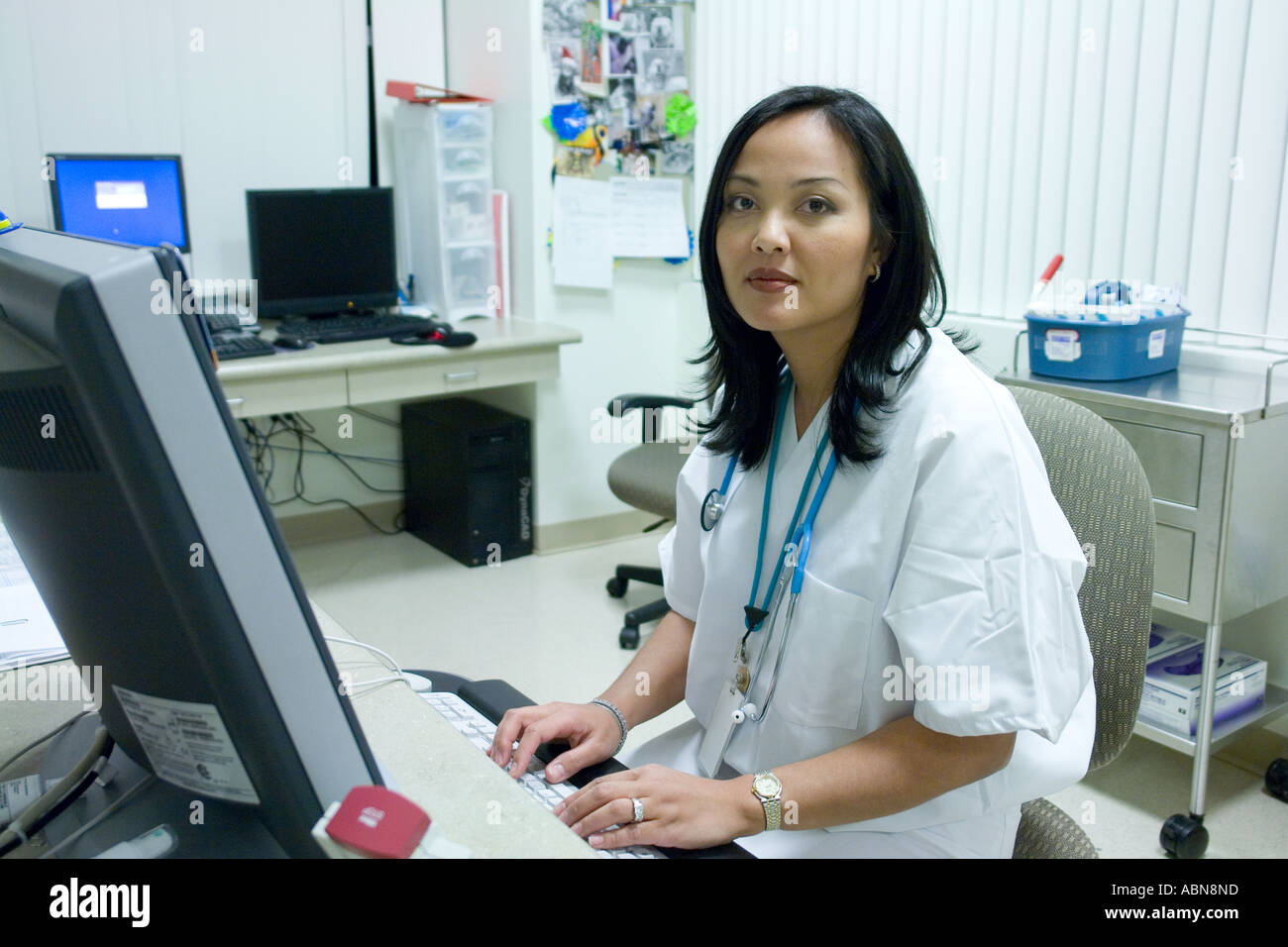 Portrait of young nurse on computer Stock Photo - Alamy