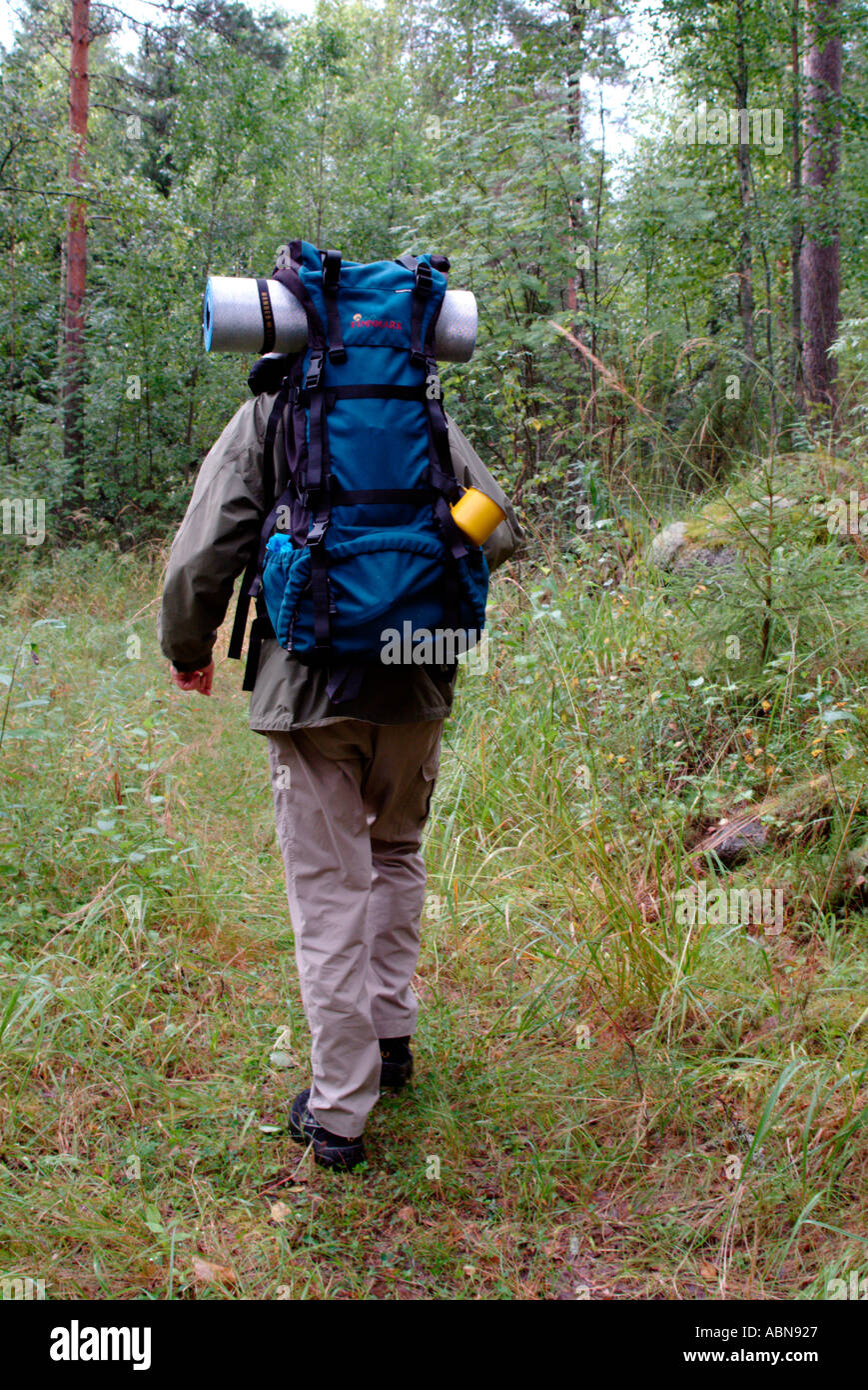 man with rucksack hiking into a forest MR Stock Photo - Alamy