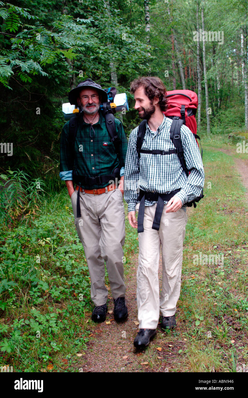 two men with rucksacks hiking in a forest MR Stock Photo - Alamy