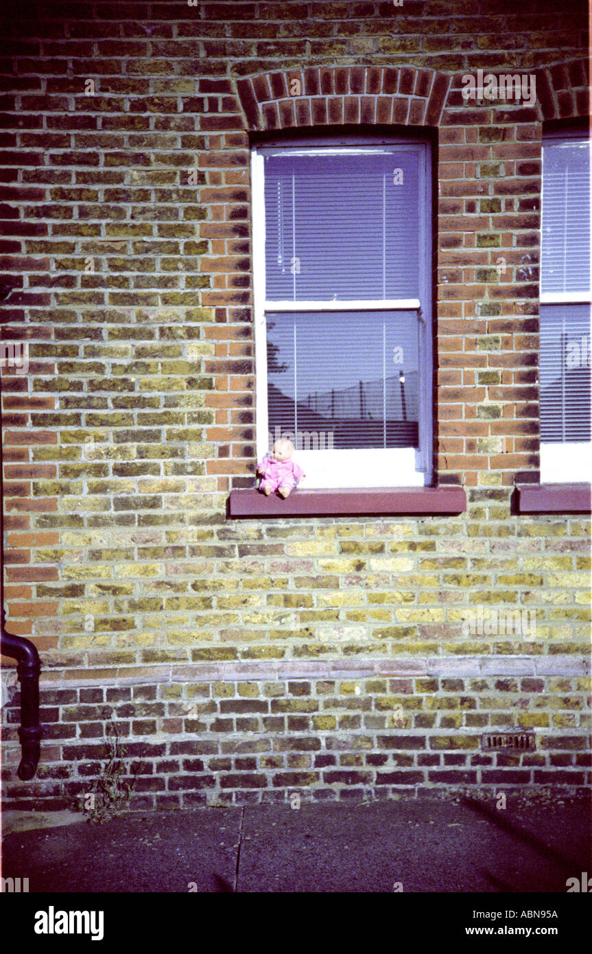 Doll on window ledge Stock Photo - Alamy