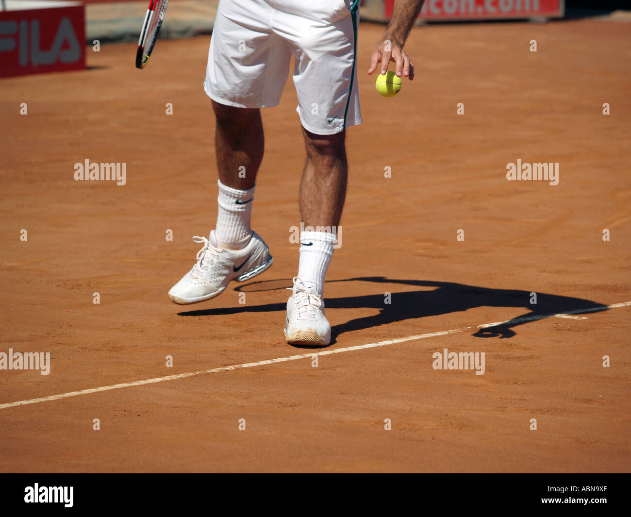tennis player bouncing tennis ball before serving Stock Photo - Alamy