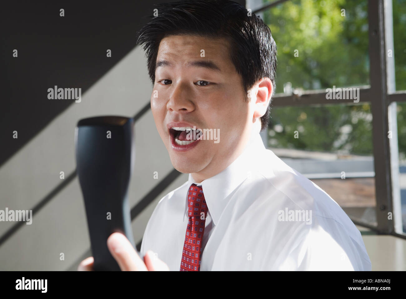 Businessman gasping at the phone Stock Photo - Alamy