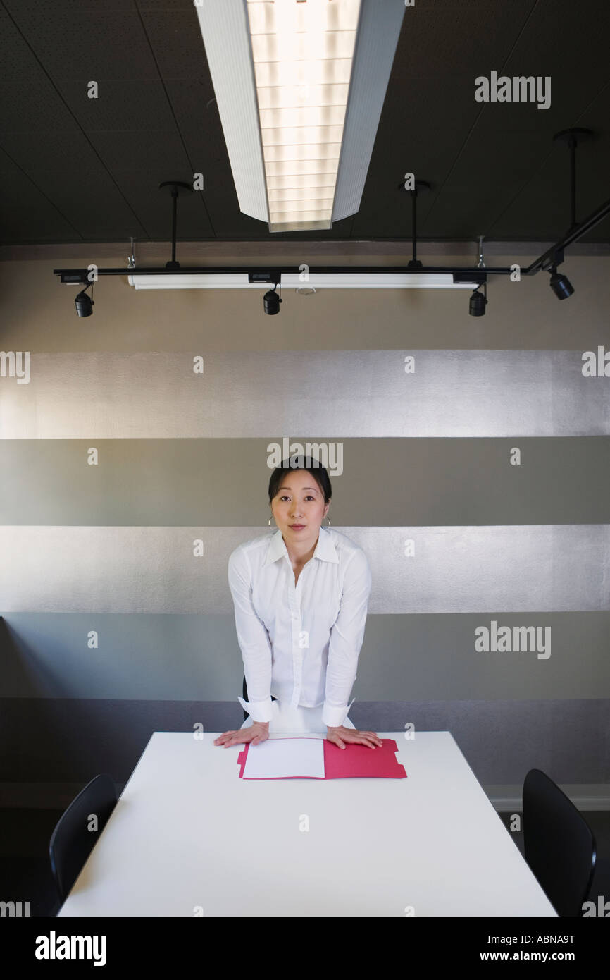 Businesswoman standing at head of conference table Stock Photo - Alamy