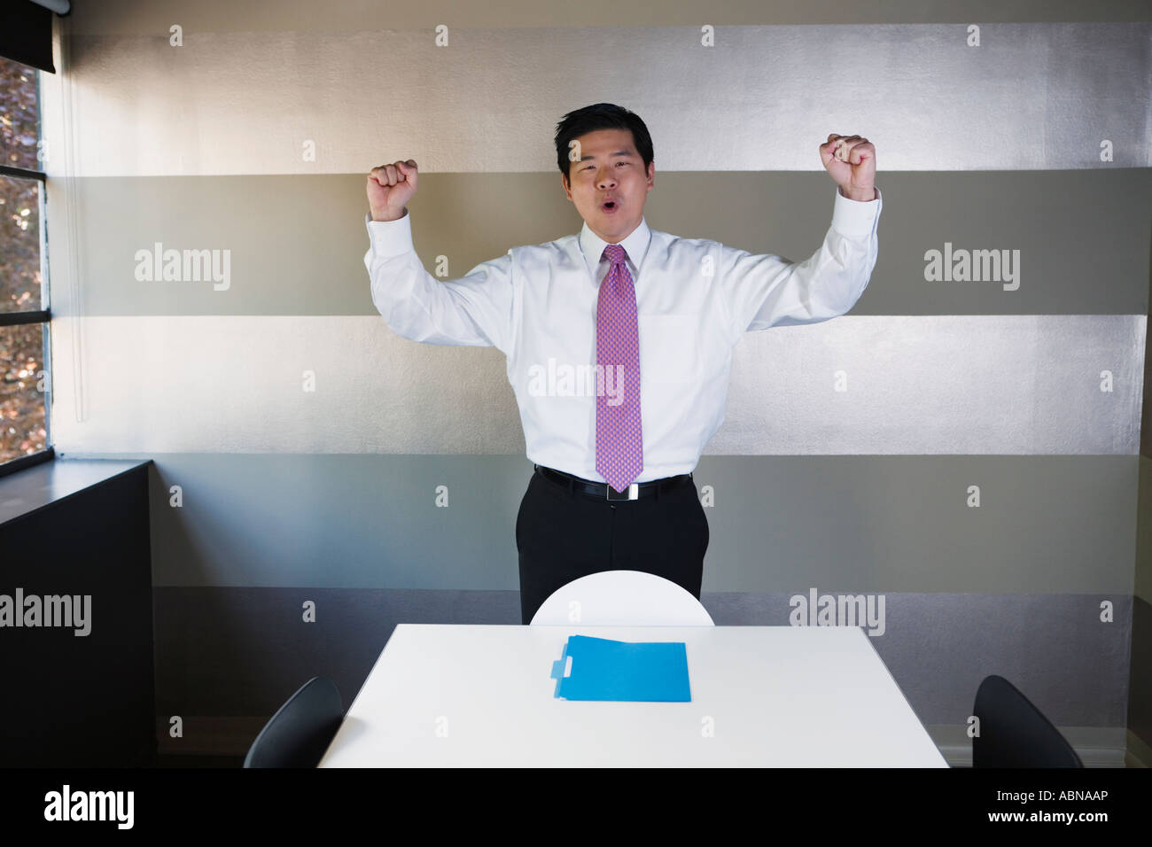 Businessman standing at head of conference table Stock Photo - Alamy