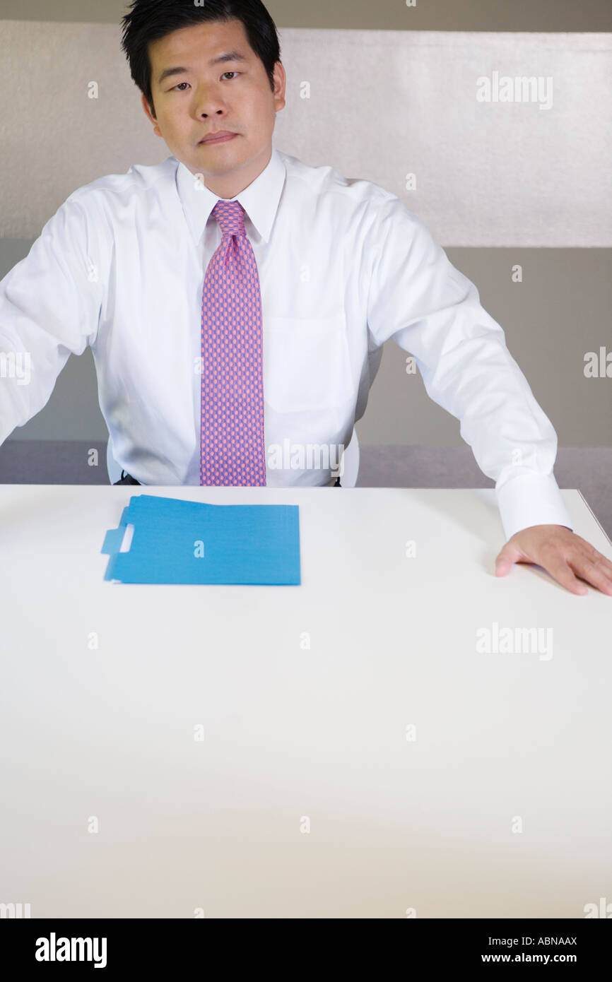 Businessman sitting at head of conference table Stock Photo - Alamy