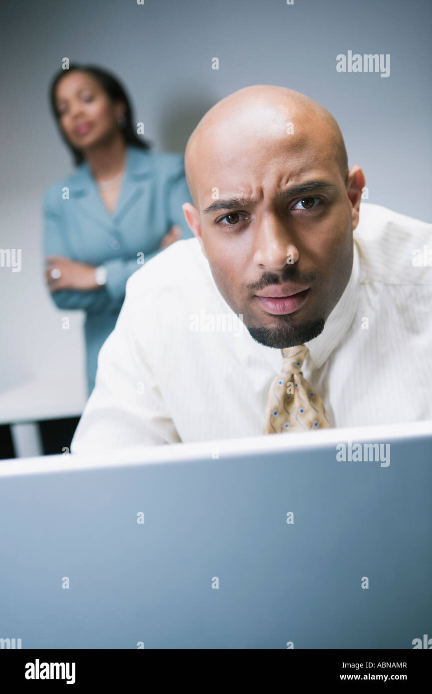 Businesswoman supervising male colleague’s work Stock Photo - Alamy