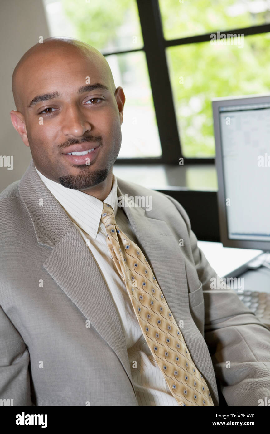 Businessman smiling at his desk Stock Photo - Alamy