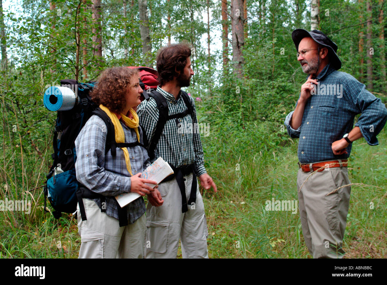 meeting in a forest young couple hiking in the nature talking with a ...