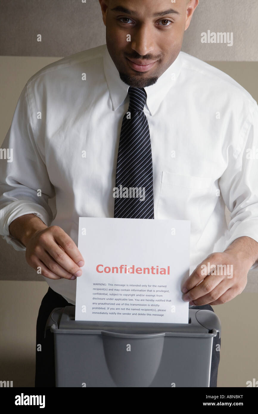 Businessman shredding “confidential” paper Stock Photo - Alamy