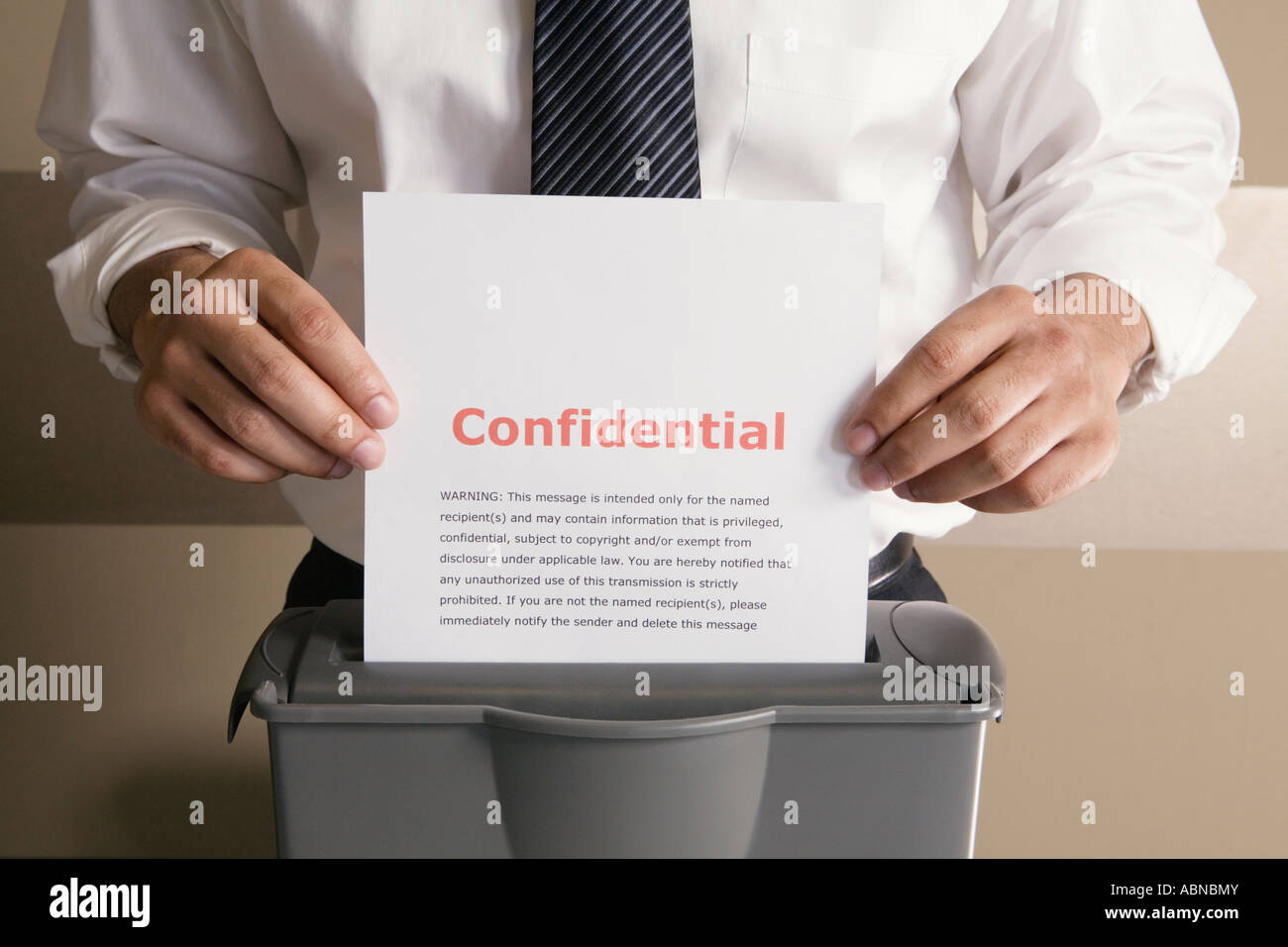 Businessman shredding “confidential” paper Stock Photo - Alamy