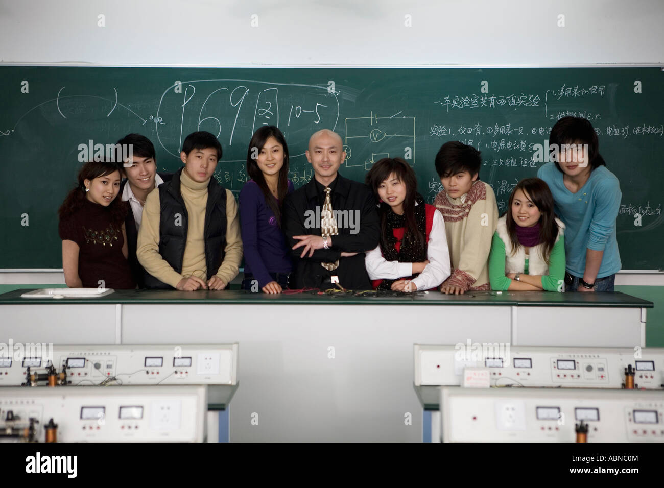 Teacher and class standing at chalkboard Stock Photo - Alamy