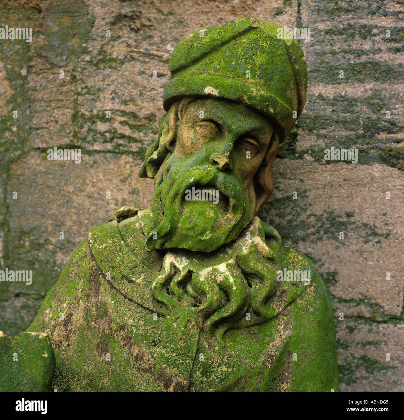 Lincolnshire Crowland Abbey mossy medieval stone figure in churchyard ...