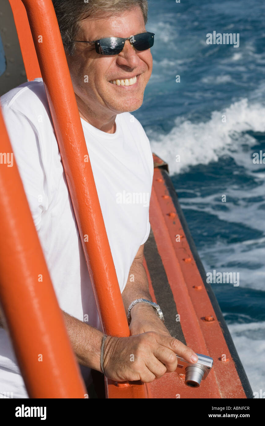Man standing on ship deck Stock Photo - Alamy