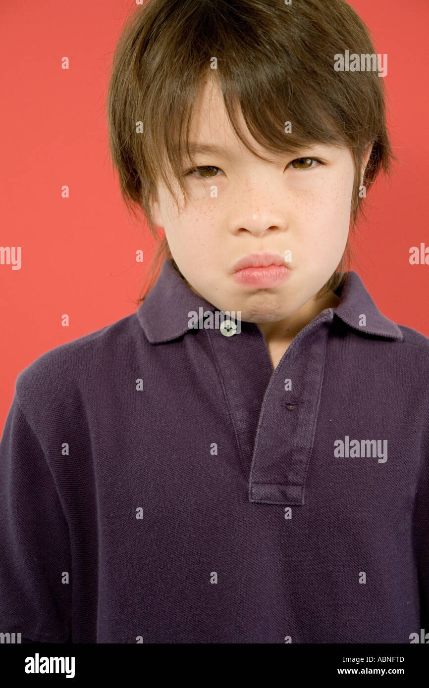 Portrait of Asian boy looking mad Stock Photo - Alamy