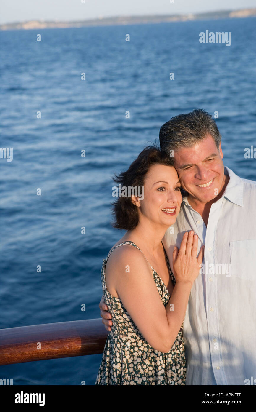 Couple standing on ship deck Stock Photo - Alamy