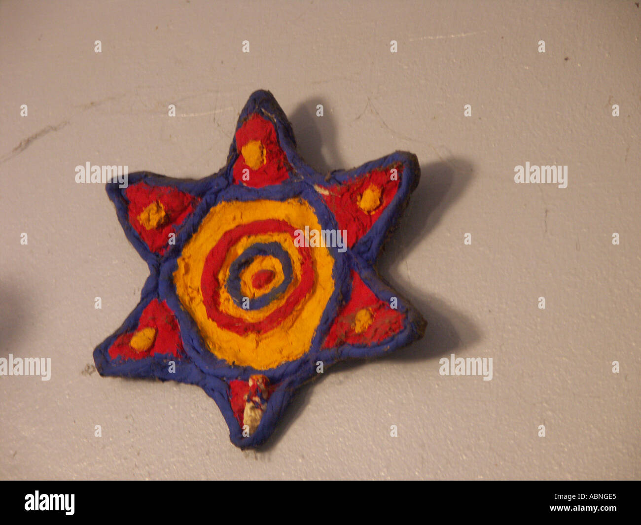 little hand painted clay star hanging as a decoration in the house of ...