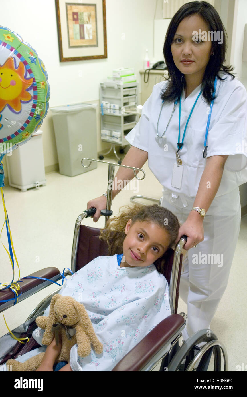 Portrait of nurse pushing young patient in wheelchair Stock Photo - Alamy